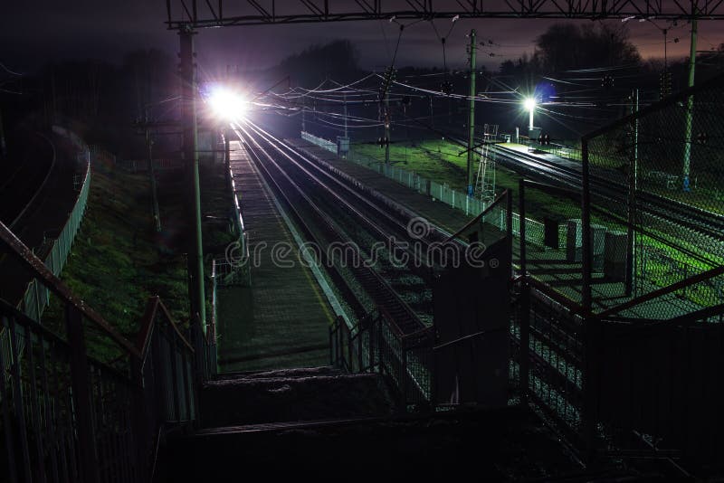 Railway Station at Night with a Passing Train Stock Photo - Image of ...