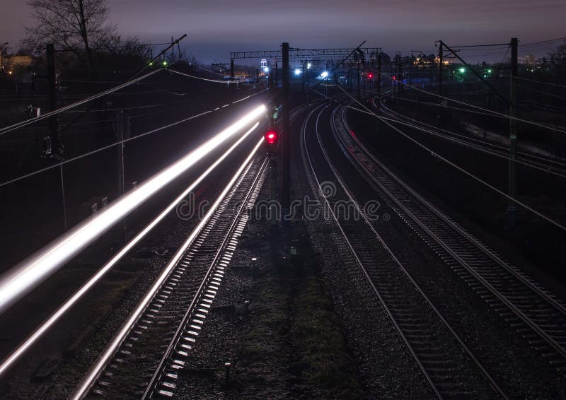 Railway Station at Night with a Passing Train Stock Photo - Image of ...