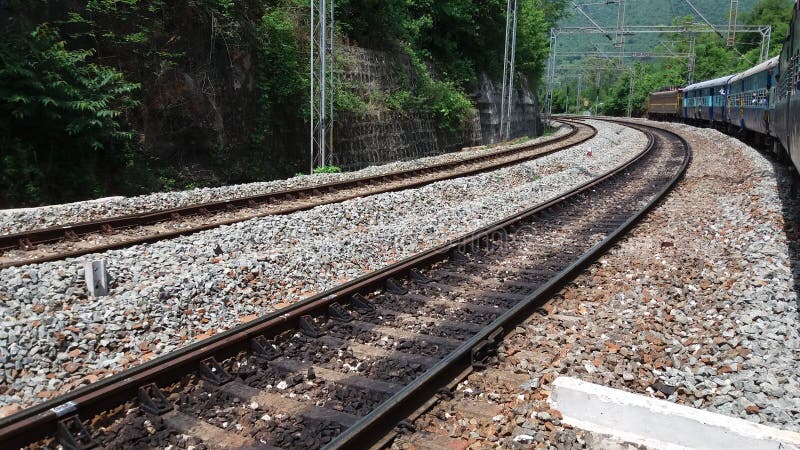 Railway Track and a Train Taking Turn on the Track Stock Photo - Image ...