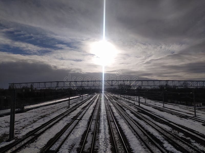 Railway Tracks in the Snow with Sun Rays Stock Image - Image of covered ...