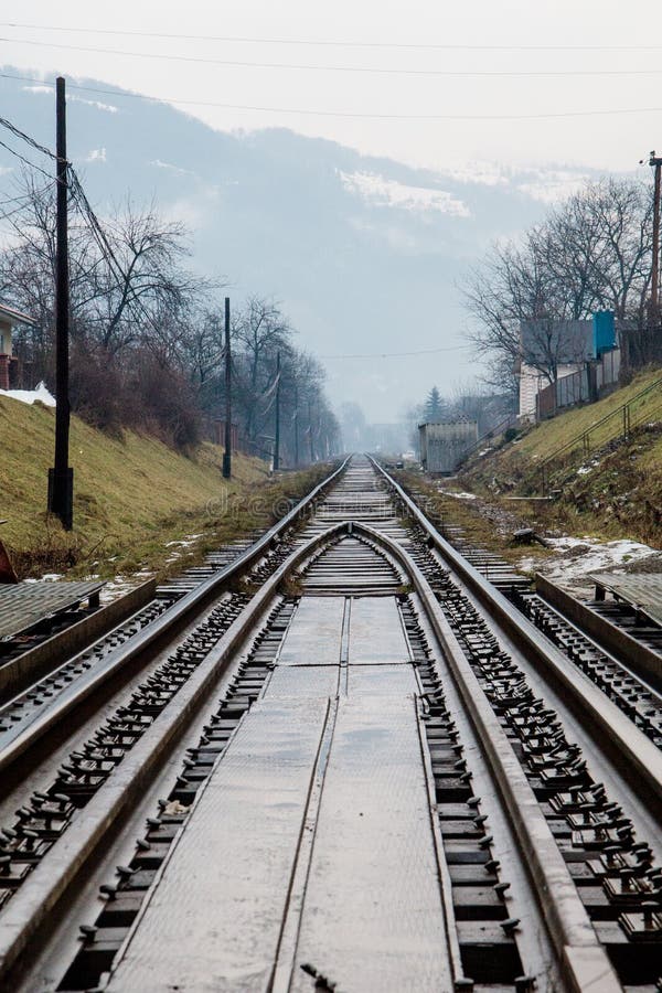 Railway Tracks in Village in Mountains Stock Photo - Image of track ...
