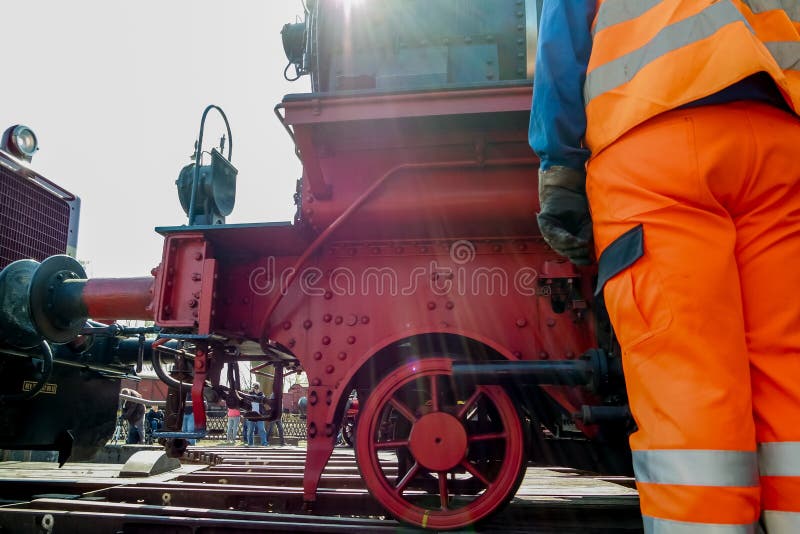 Railway Worker in Action with Steam Train in Background Stock Image ...