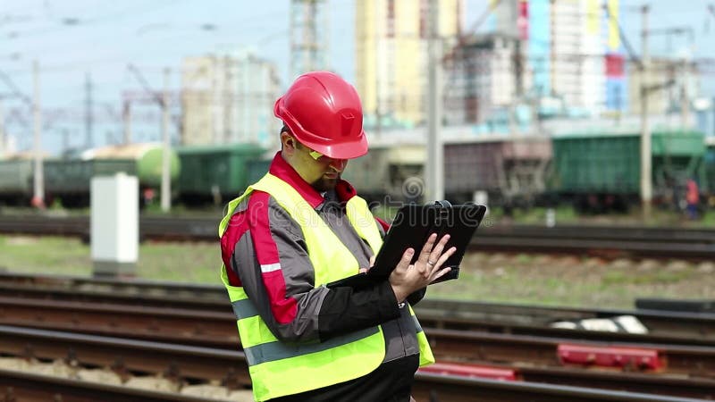 Railwayman with Computer at Freight Train Terminal Stock Footage ...