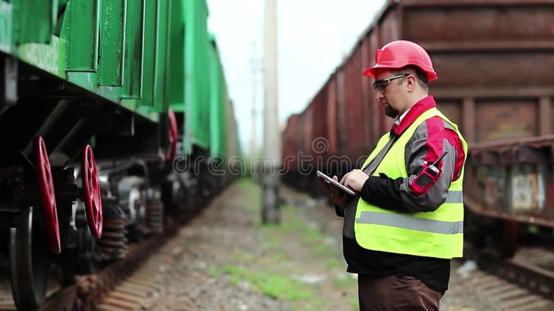 Railwayman with Tablet Pc between Freight Trains Stock Video - Video of ...