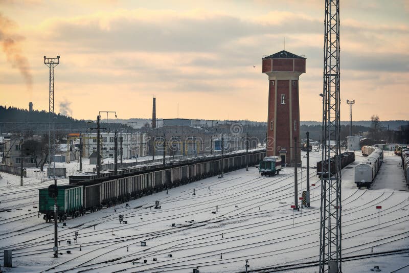 Railways with Train in Winter with Big Red Brick Tower in Sunset Stock ...