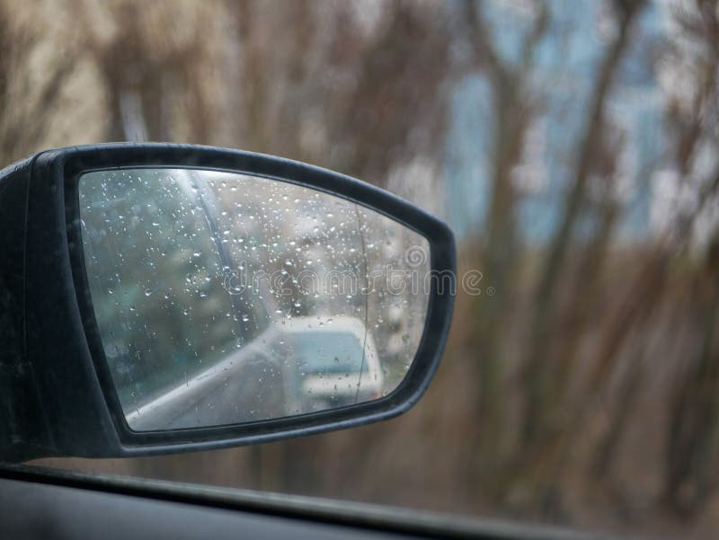 Rain Behind the Glass of a Car. Rain Droplets Flow Down the Car Glass ...