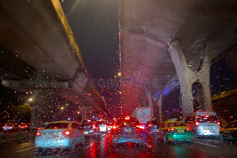 Rain on Car Windshield and Illuminated Tail Lights Seen from Inside Car ...