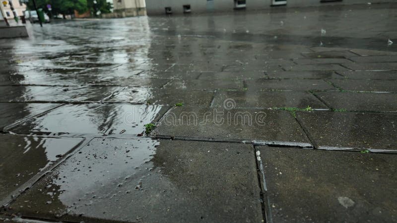 Rain in the City. View of Raindrops Falling on the Pavement Raindrops ...