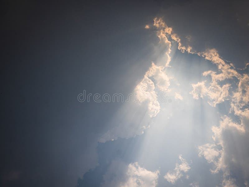 Clouds Part To Reveal Sun Shining Over Mountain in Purple Dusk Stock ...