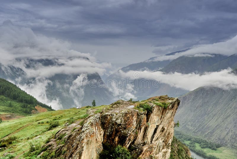 Rain Clouds Over Mountain Tops. Sheer Cliffs Over the River Valley ...