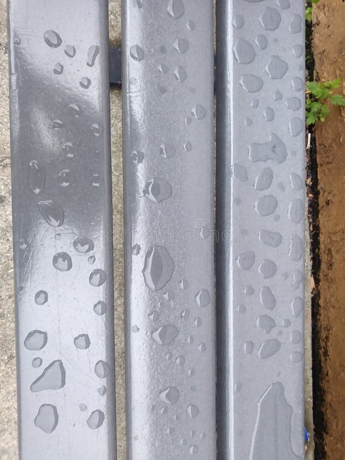 Rain dew covered bench stock image. Image of rain, rainfall - 128696133