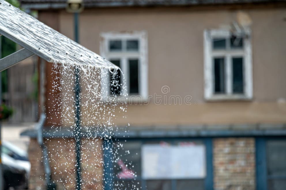 Rain Dripping from Awning in Front of Building. Background with ...
