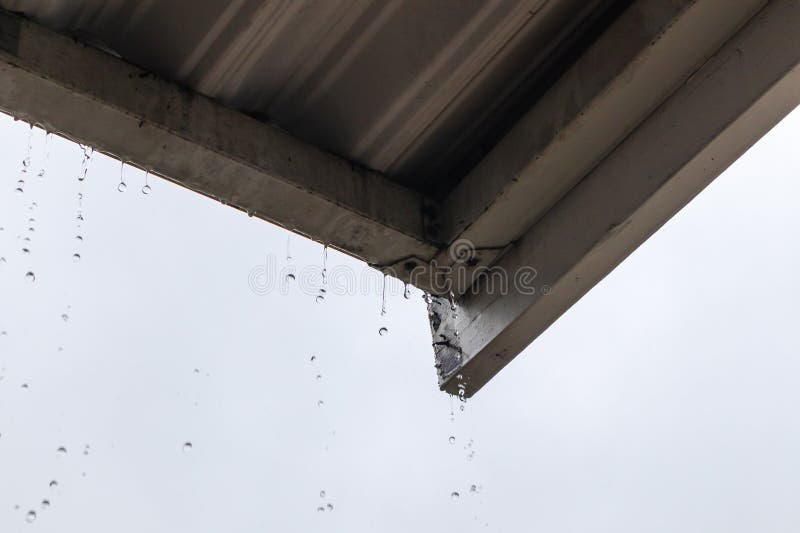 Rain Dripping Off the Side of a Metal Roof Stock Photo - Image of ...