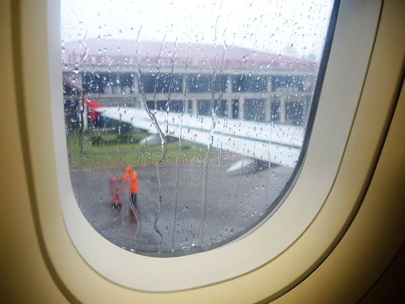 Rain on airplane window stock photo. Image of window - 147722674