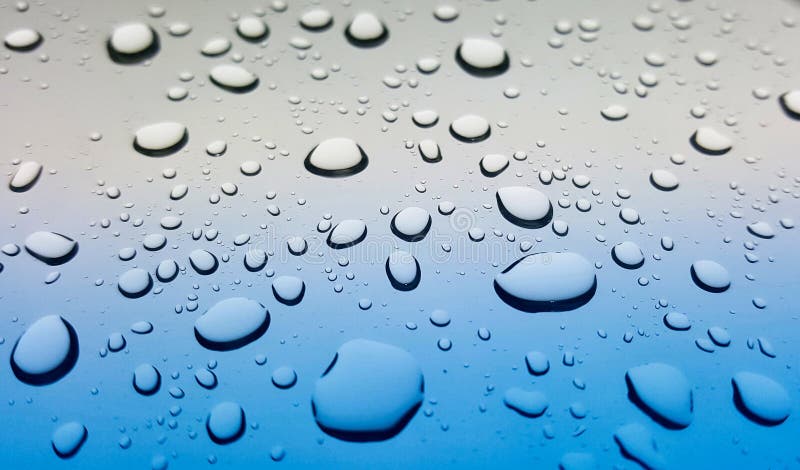 Rain Drops Beading on a Smooth Glass Surface, Low Angle View. Stock ...