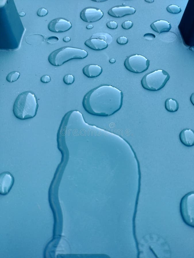 Rain drops on blue surface stock photo. Image of surface - 172408676