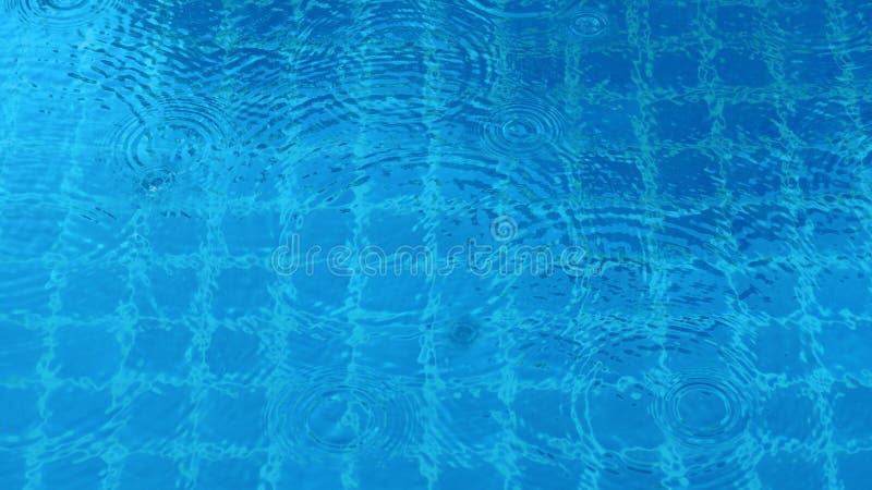 Rain Drops on Blue Water Swimming Pool Stock Photo - Image of pool ...