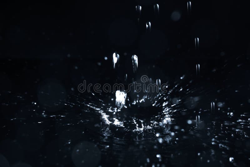 Rain Drops Falling Down into Puddle on Background Stock Image - Image ...