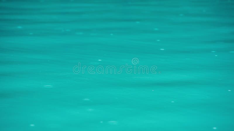 Rain Drops Falling Onto the Blue Lake Surface Stock Footage - Video of ...