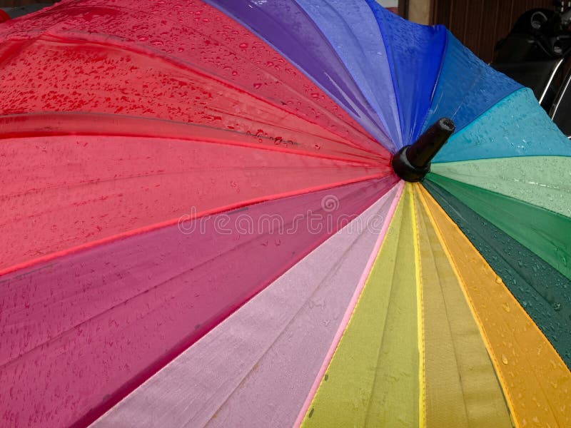 Rain Drops Falling Onto Umbella with Rainbow Colour Stock Photo - Image ...