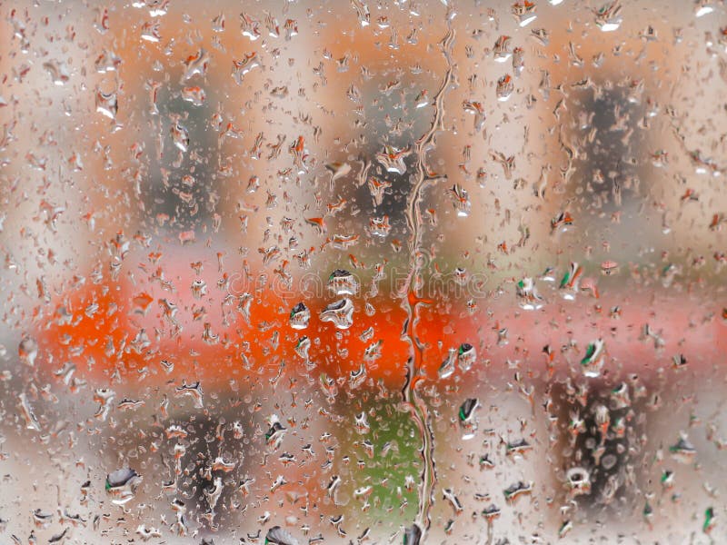 Rain Drops on Glass Window. the Cityscape Outside the Window in a Blur ... Rain Drops on Glass Window. the Cityscape Outside the Window in a Blur ...