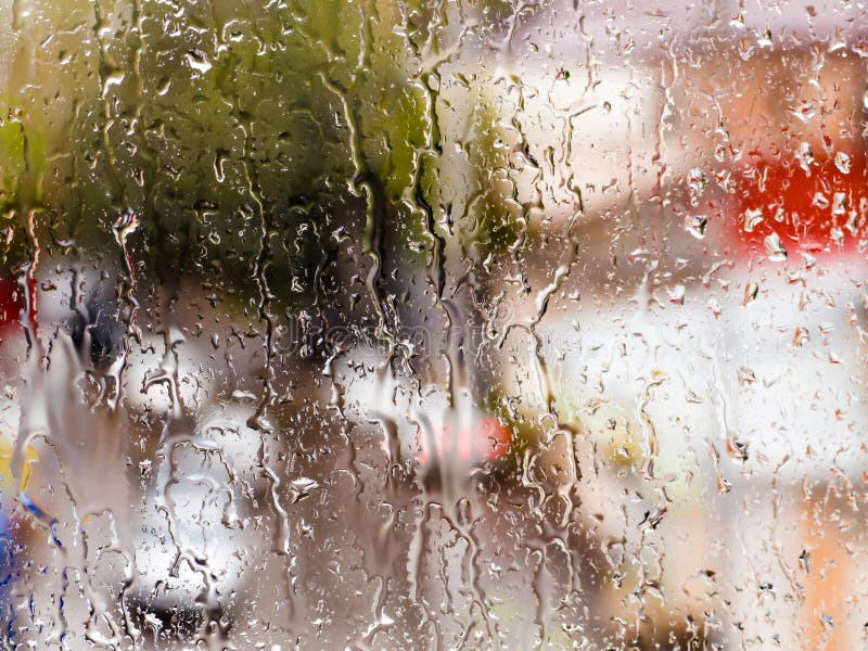 Rain Drops on Glass Window. the Cityscape Outside the Window in a Blur ...