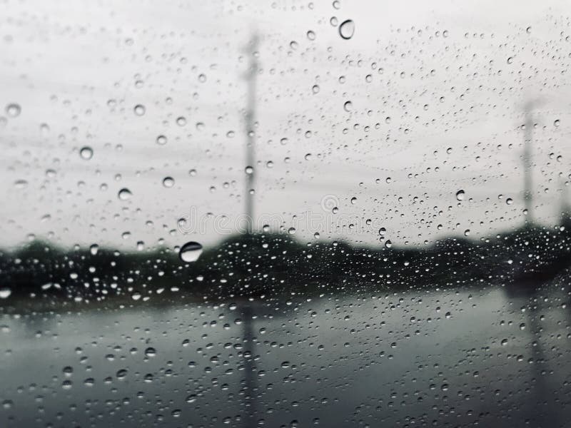Rain Drops on the Side of the Car Running on the Street. in the ...