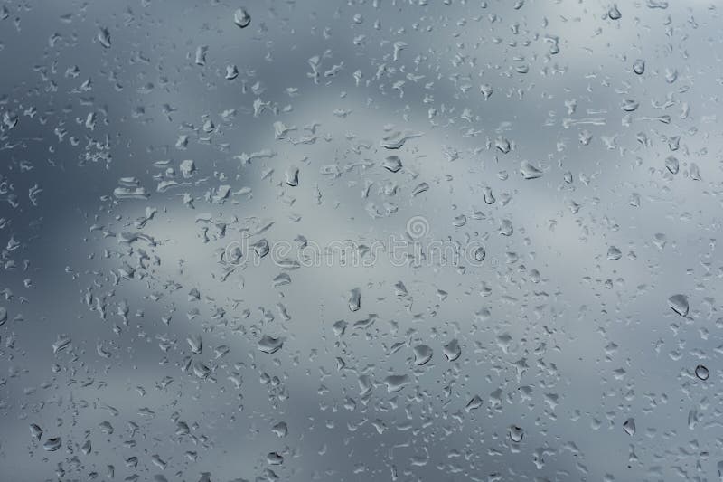 Rain Drops are Visible on a Window Glass, Creating a Textured Pattern ...