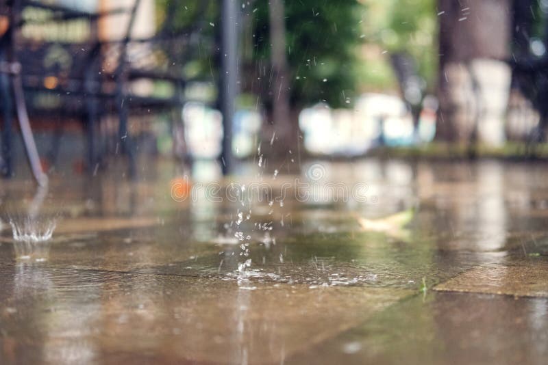 Rain drops on wet pavement stock image. Image of town - 136521665