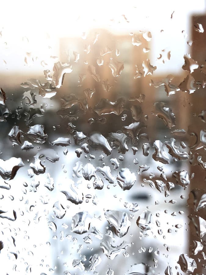 Rain Drops on Window Glass with Blurred Multi-storey Building on ...