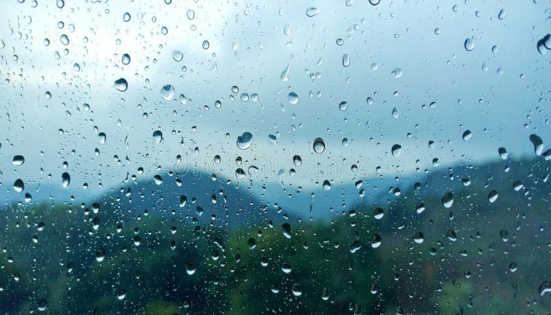 Rain Drops on a Window with Mountains and Forest Backdrop in Overcast ...