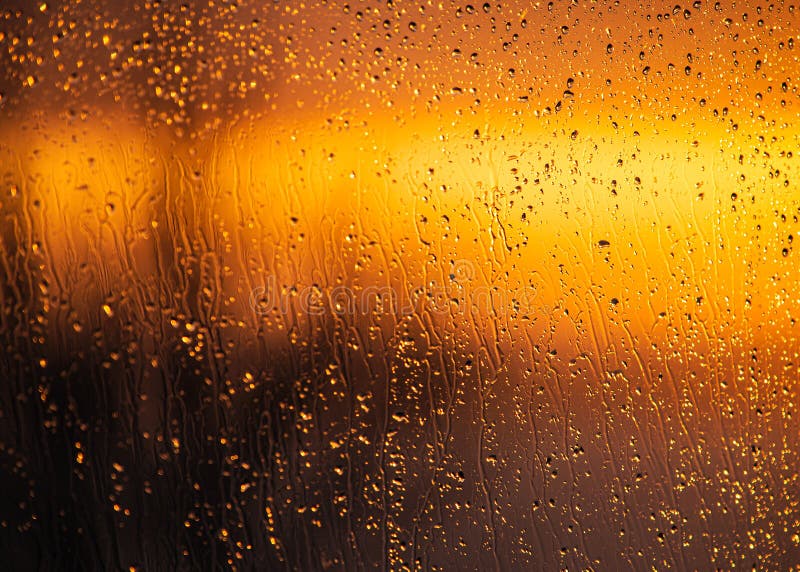 Rain Drops on a Window during a Sunset Creating a Golden Abstract ...
