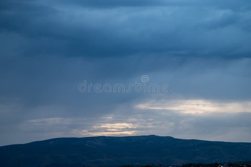 Rain Falling in the Distance with the Last Rays of the Sun Stock Image ...