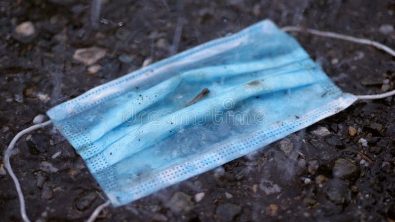 Rain Falling on a Face Mask on the Ground Stock Image - Image of cloudy ...