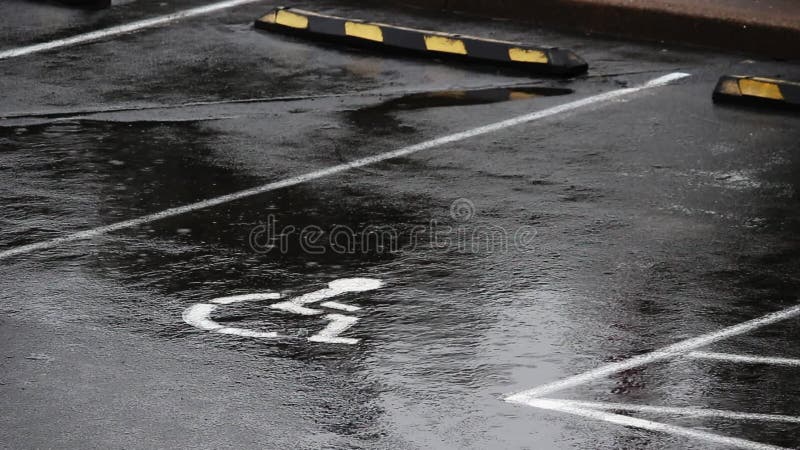 Rain Falling on Parking Lot with Handicap Symbol Stock Footage - Video ...