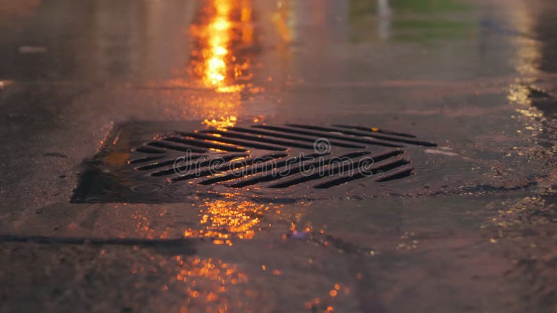 Rain Falling in Slow Motion Down a Sewer Drain at Night. Stock Video ...