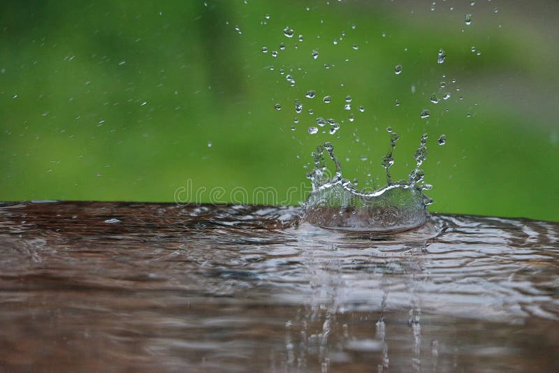 Rain is Falling on a Wooden Table Full of Water in the Garden Stock ...