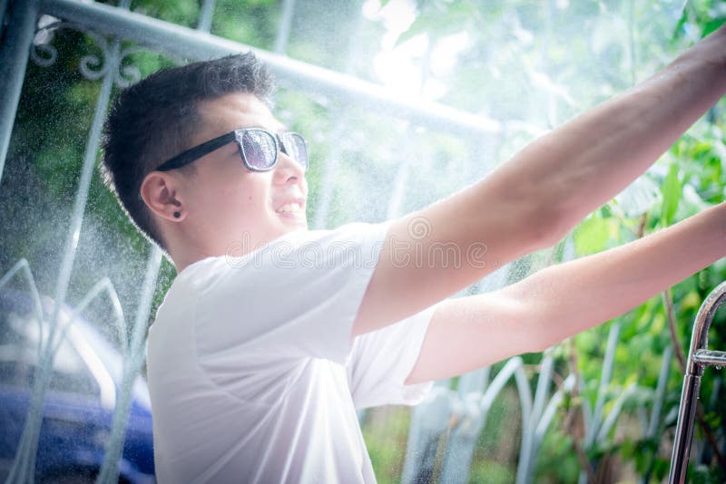 The Rain Falls, the Drops Fall on His Face and the Girl is Happy with ...