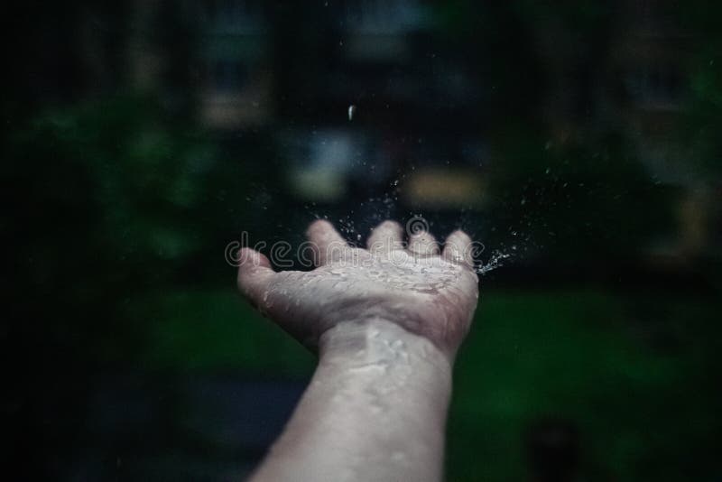 Rain on Hand. Close-up of the Moment when a Stream of Rain Flows into ...