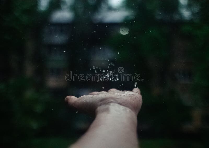 Rain on Hand. Close-up of the Moment when a Stream of Rain Flows into ...