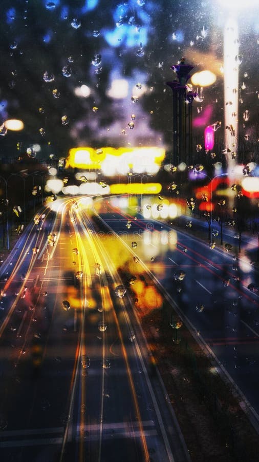 Rain at Night on the Road with Street Lights in the Dark Street Stock ...