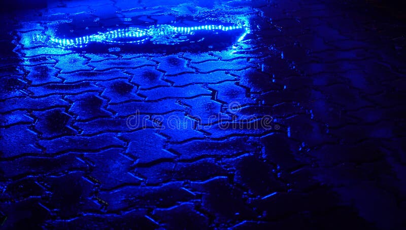 Rain on the Night Street. Blue Light Reflection in Puddle. Stock Image ...