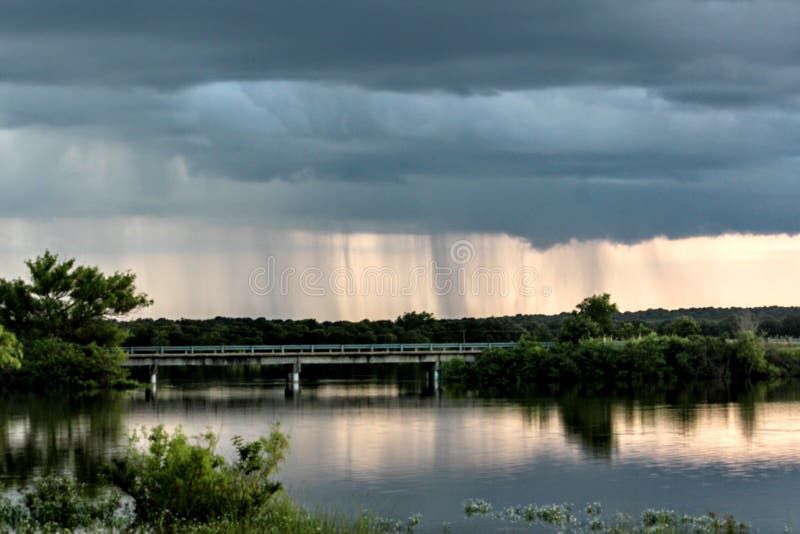 Rain over the bridge stock image. Image of clouds, lake - 149538785