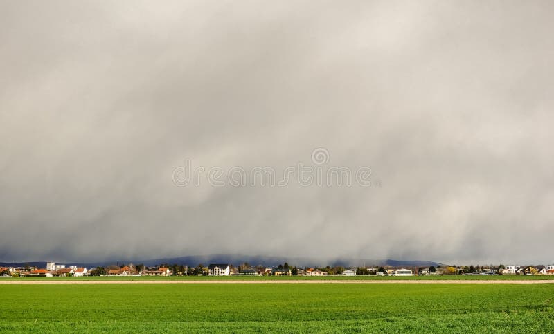 Rain Over a Village and a Fresh Green Meadow in the Foreground the ...