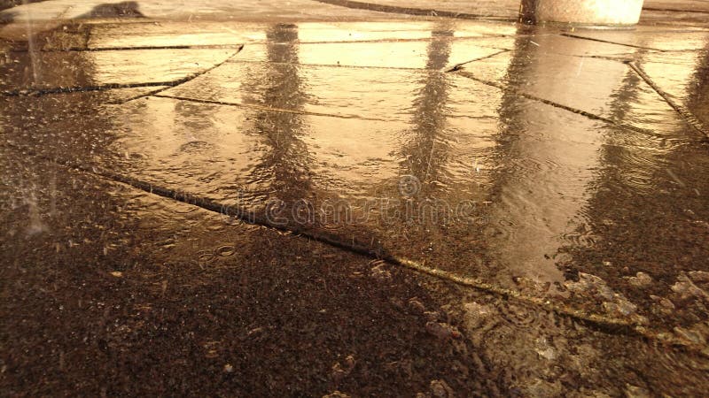 Rain on Pavement Stones stock image. Image of melted - 64381865
