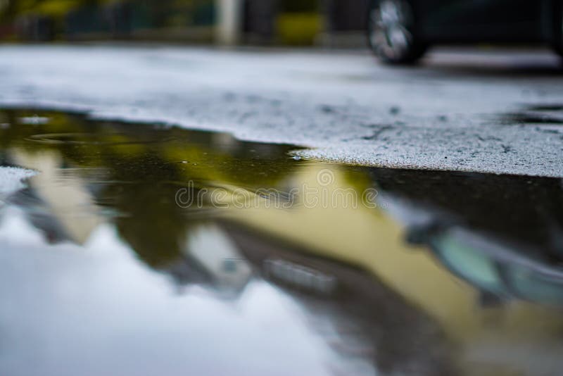 Rain puddle on the street stock image. Image of rain - 191039639