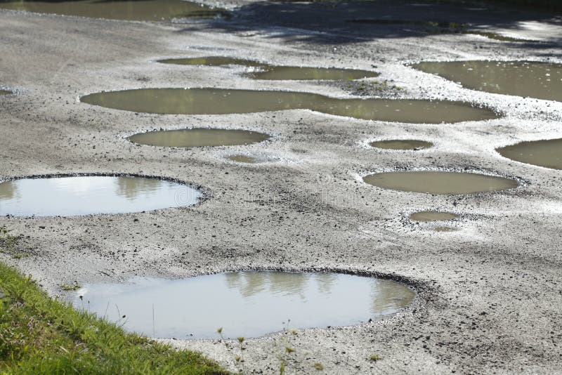 Rain puddles stock photo. Image of pavement, puddles - 98378786