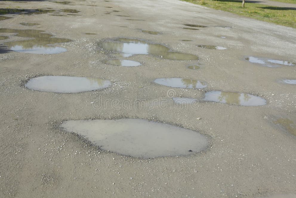 Rain puddles stock photo. Image of rain, puddles, footpath - 98379244