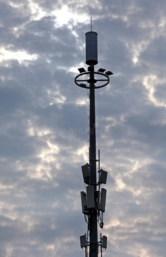 5G Base Station Communication Tower on Sky Dark Clouds Background ...