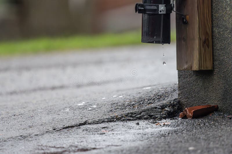 Rain Water Dropping from a Pipe on a Wall.. Stock Photo - Image of ...
